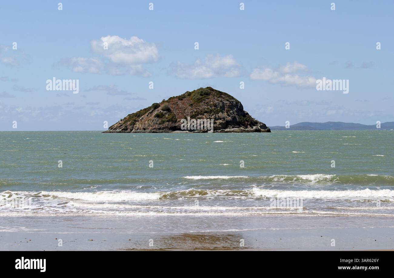 Bluff Rock and a beach with the ocean and sand at Yeppoon in Queensland ...