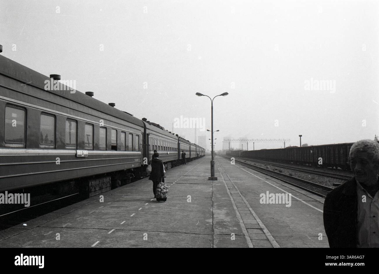 Passenger at Rural Chinese Train Station with Green Carriages - Early ...