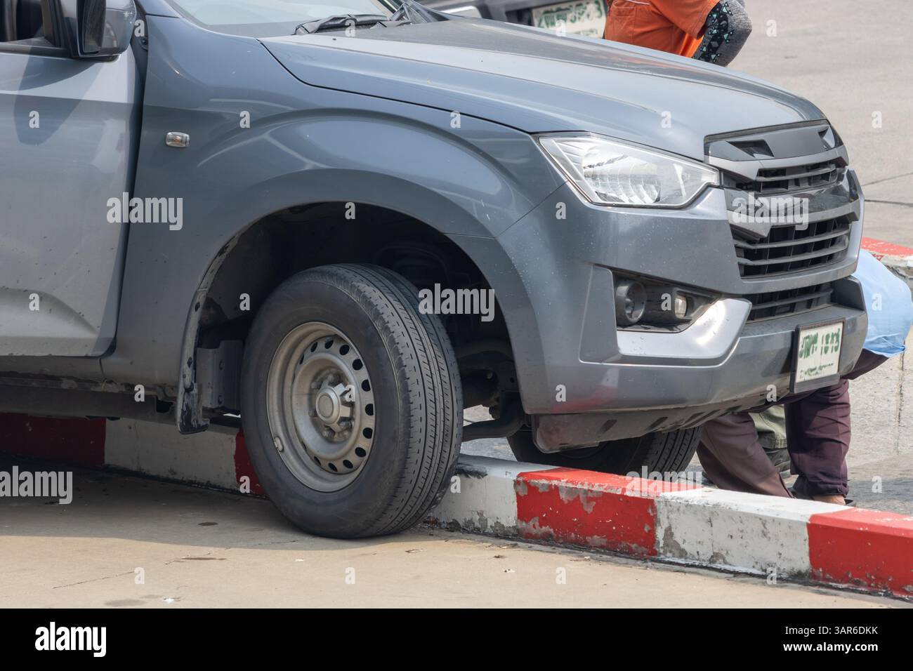 The pick up car went over the curb and got stuck on the side of the ...