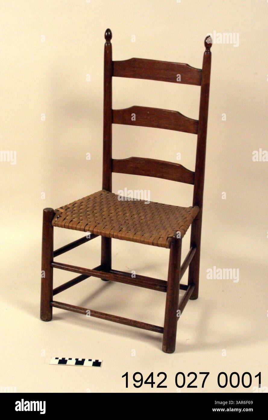 This wooden slat-back side chair features peg construction with a woven ...