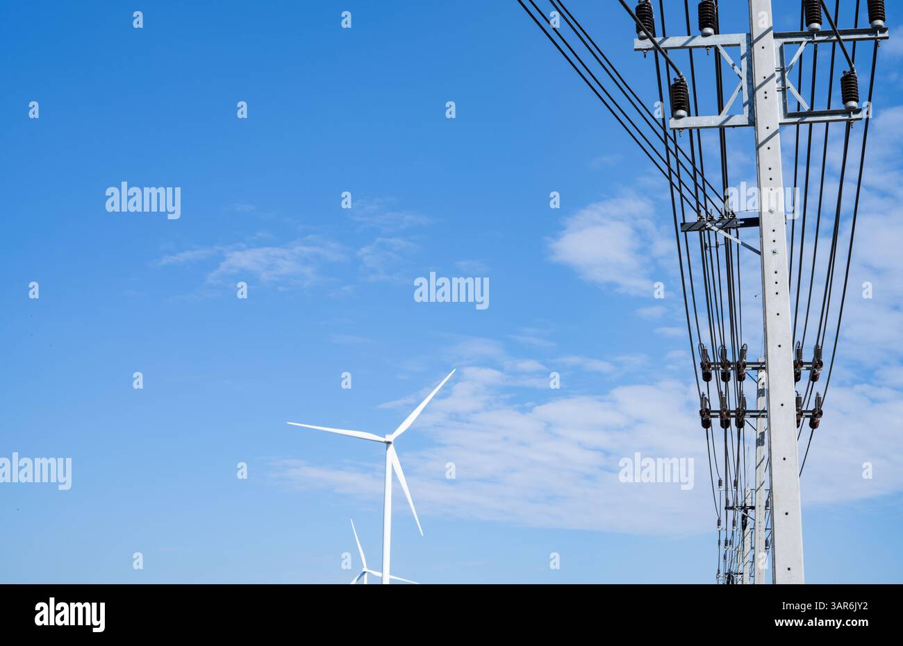 Electricity transmission tower under blue sky, collecting wind power ...