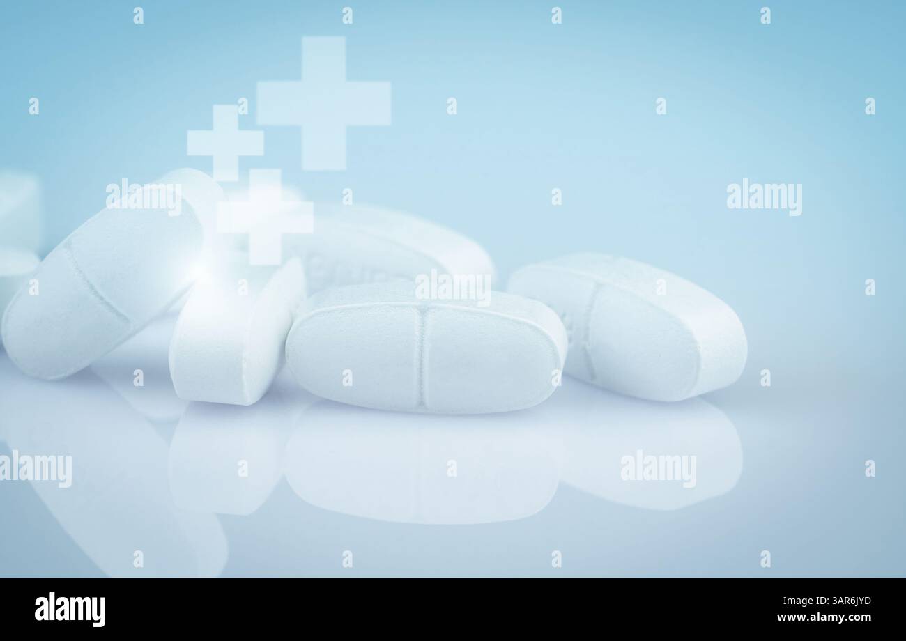Pile of white antibiotic tablets on smooth gradient background ...