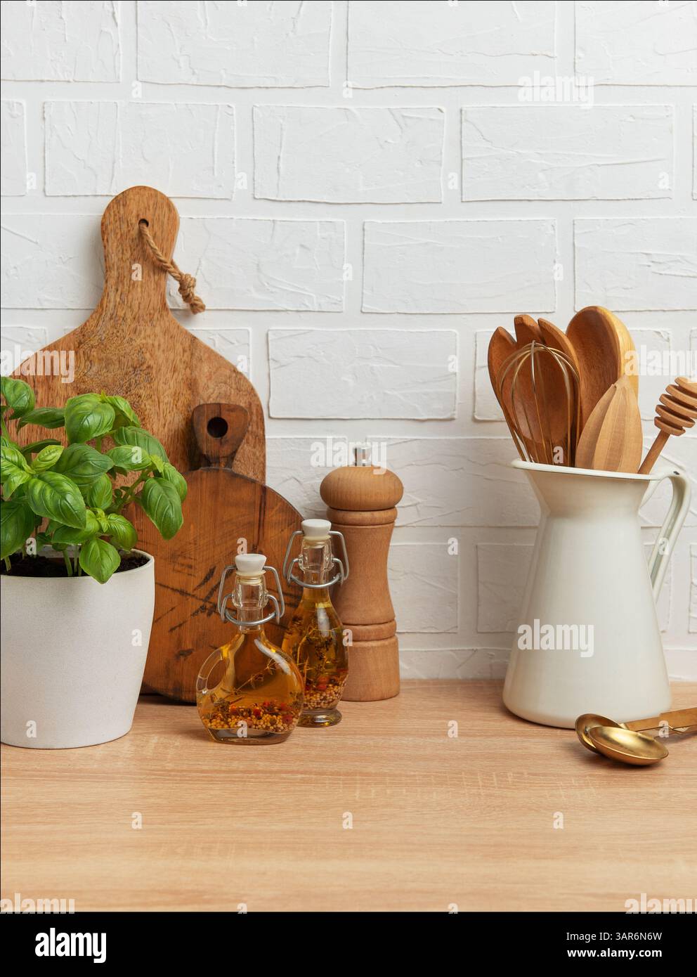 Cozy kitchen setup featuring basil, utensils, and wooden accents Stock ...