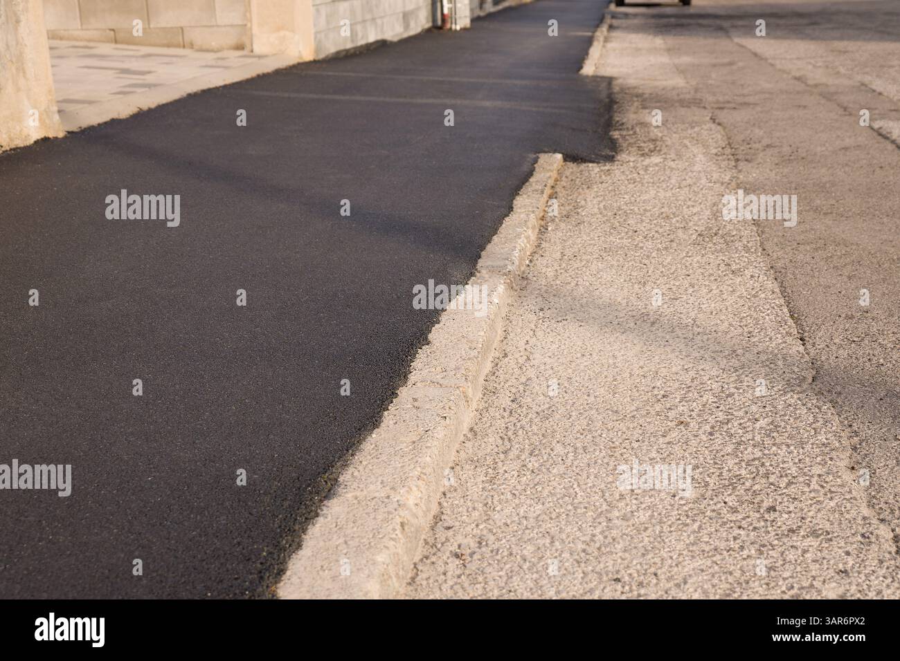 Asphalt driveway curb ramp in residential area Stock Photo - Alamy