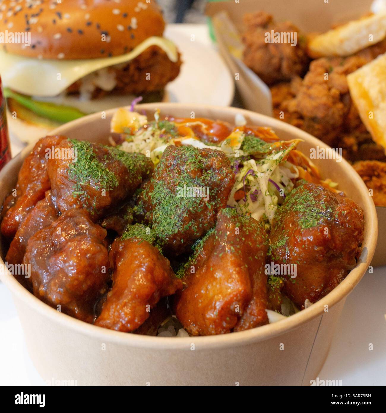 Korean deep-fried chicken on white rice with hot spicy sauce Stock ...