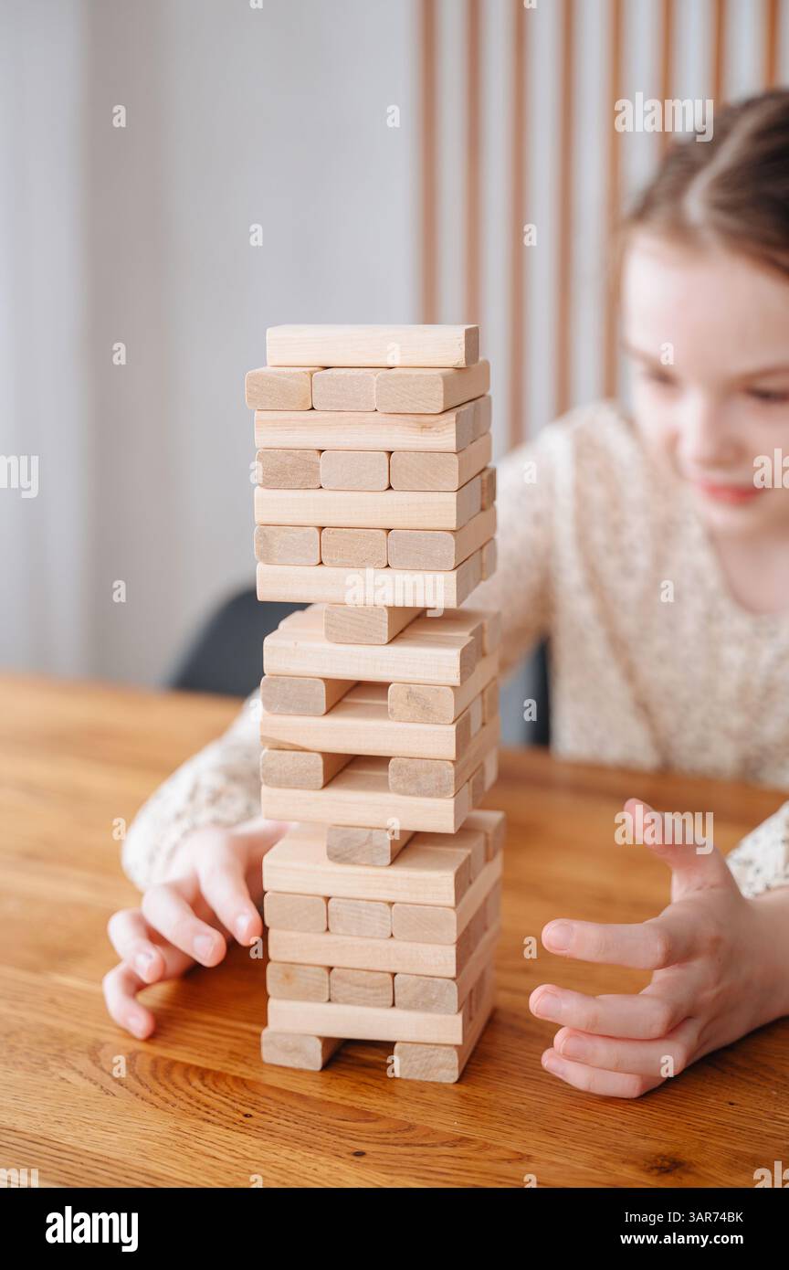 children playing educational board game at home in kitchen, girl ...