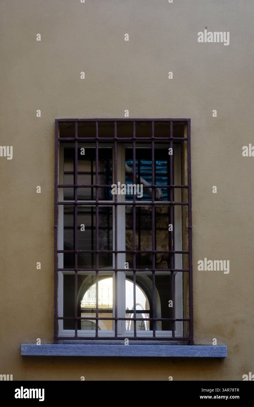 Lombardy, Italy March 1st 2025 Sunlight filtering through barred window ...