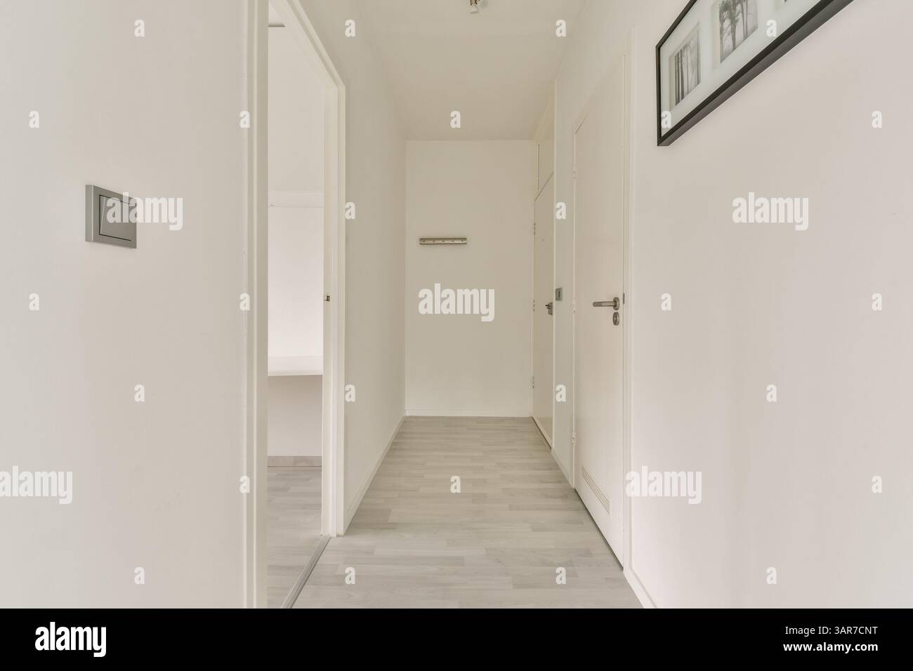 A spacious and bright corridor featuring a minimalist design ...