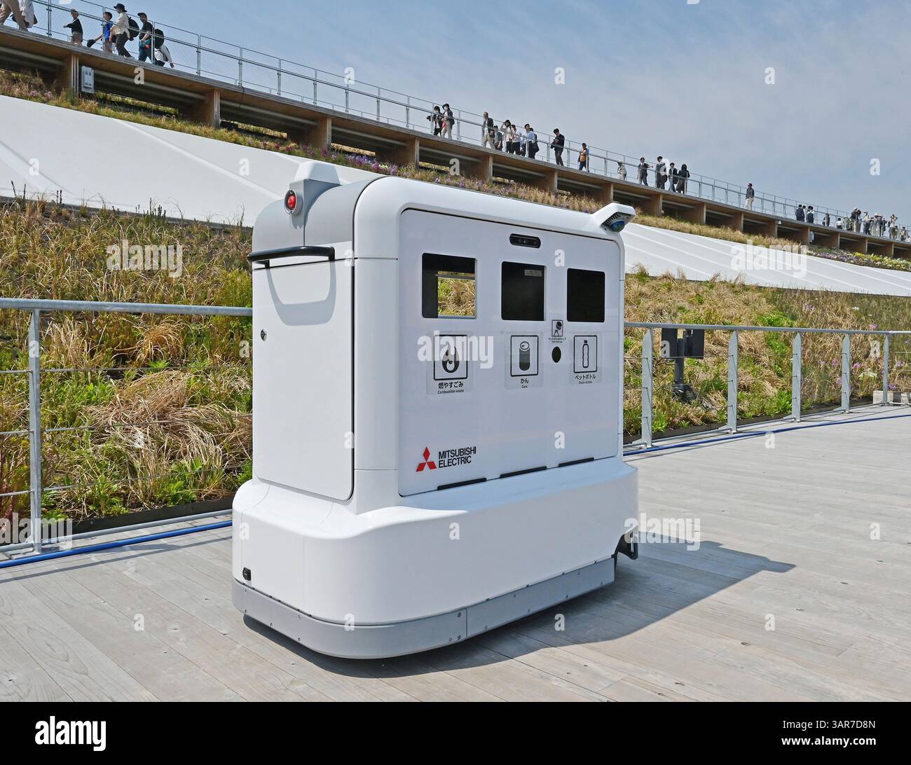 A robot for garbage moves automatically around the Grand Ring for Expo ...