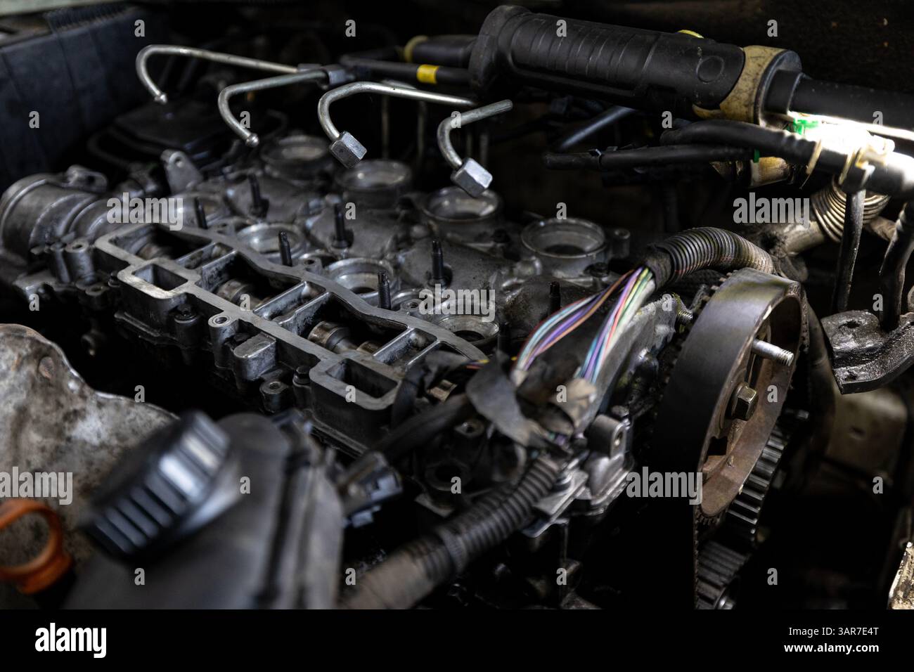 A close-up shows the upper part of a partially disassembled engine ...