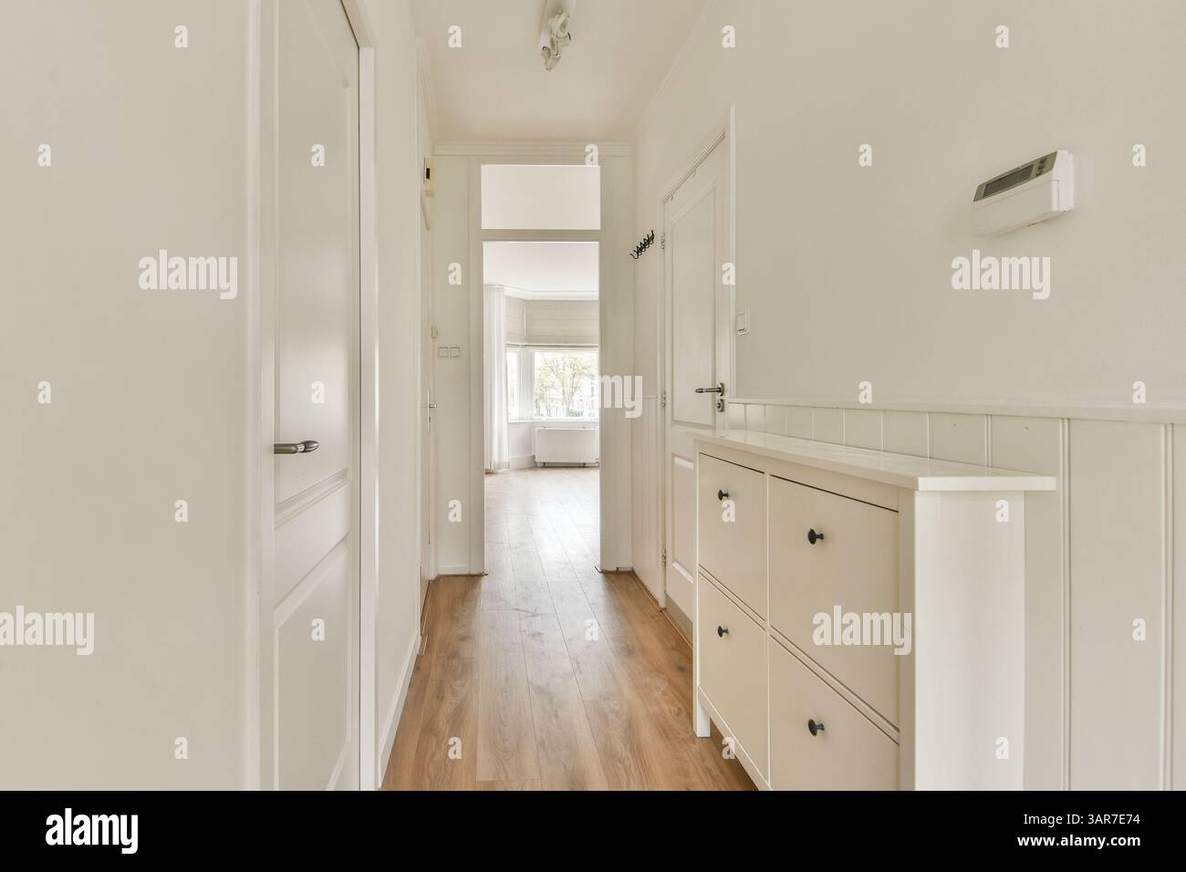 A spacious, well-lit hallway featuring clean lines and a minimalist ...