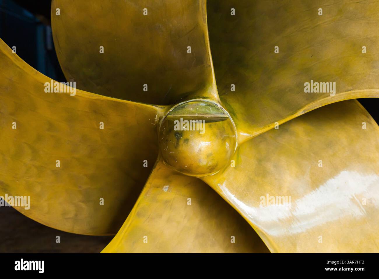 A new bronze five-bladed propeller is installed on the ship, close-up ...