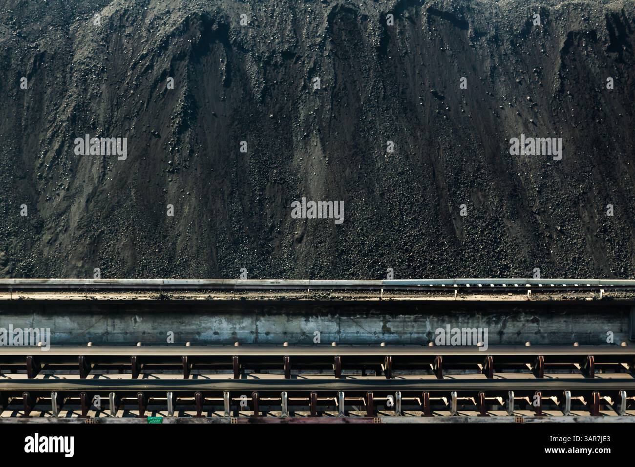 Conveyor line with coal and a huge pile of coal near the conveyor Stock ...