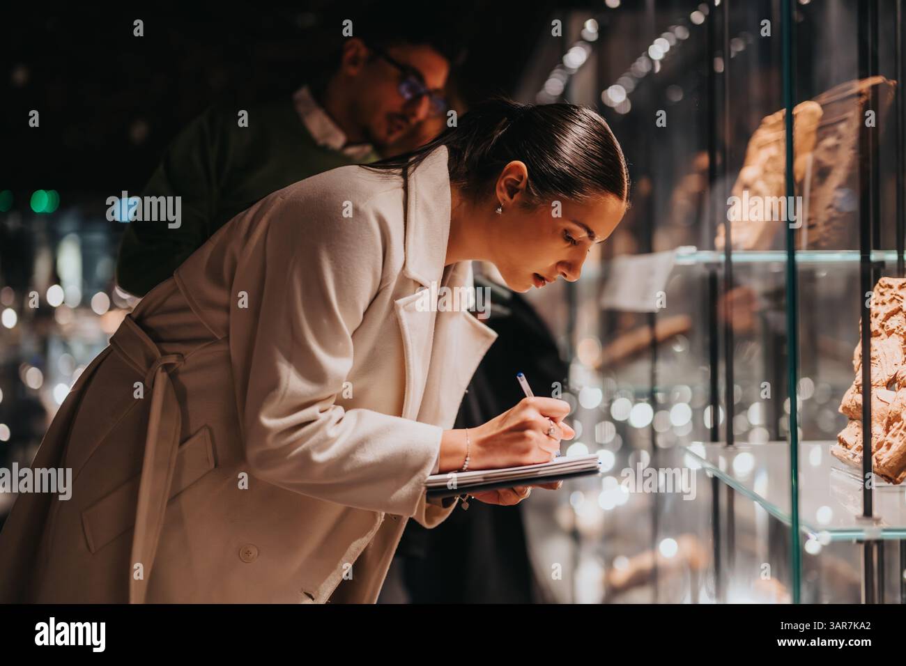 Woman Taking Notes While Observing Museum Exhibition, Illuminating ...