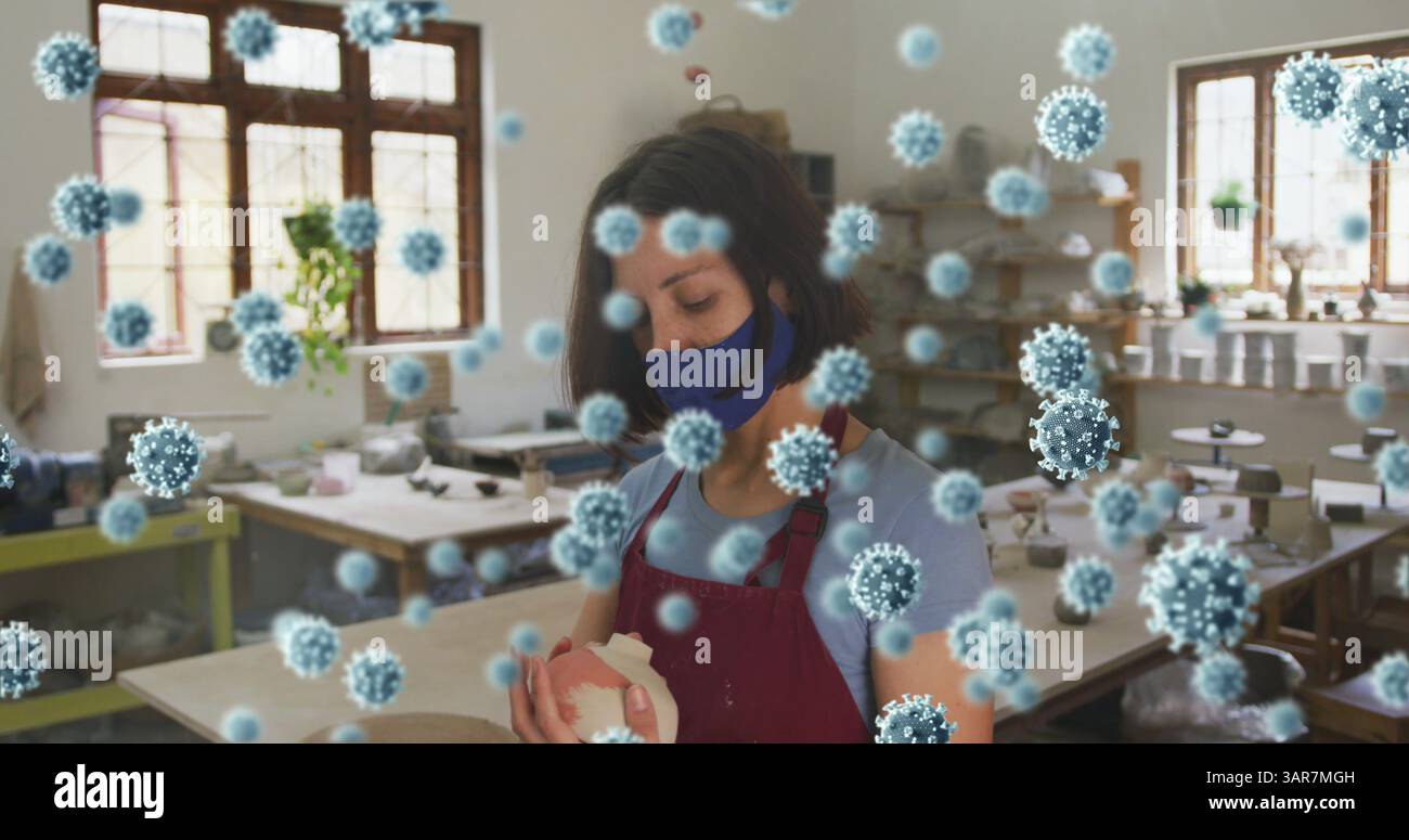 Composite image of covid-19 cells floating against female potter ...