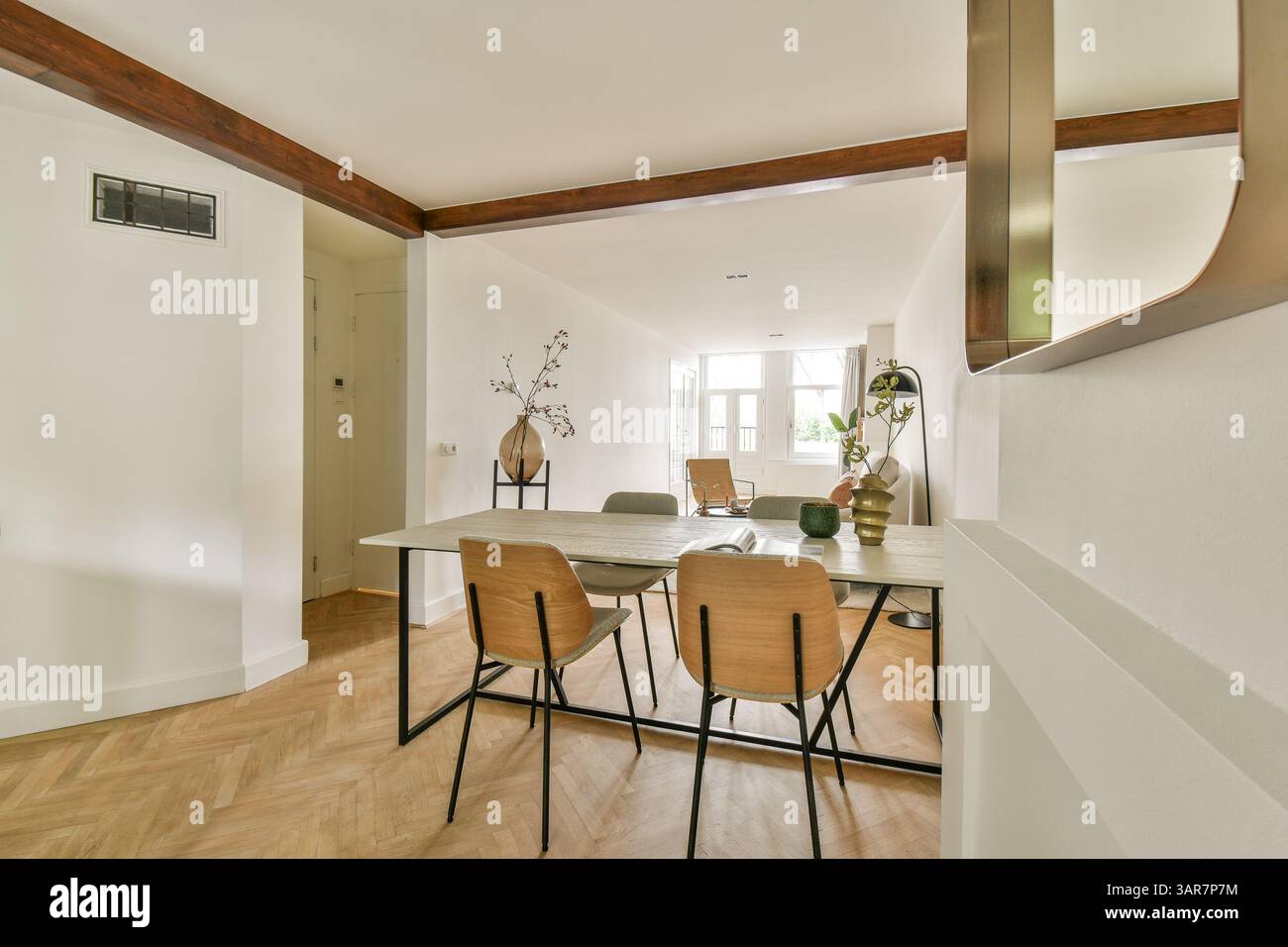 A spacious, well-lit room featuring a minimalist design with wooden ...
