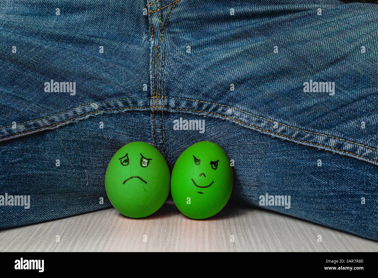 Two eggs with expressive faces sit on a white surface, positioned ...