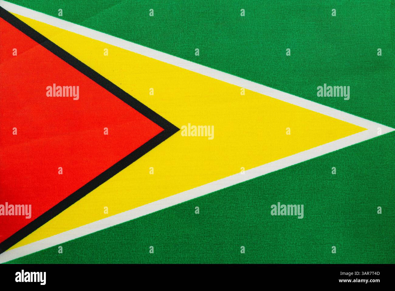 The vibrant flag of Guyana showcases bold colors and a distinctive design. The elements include ...