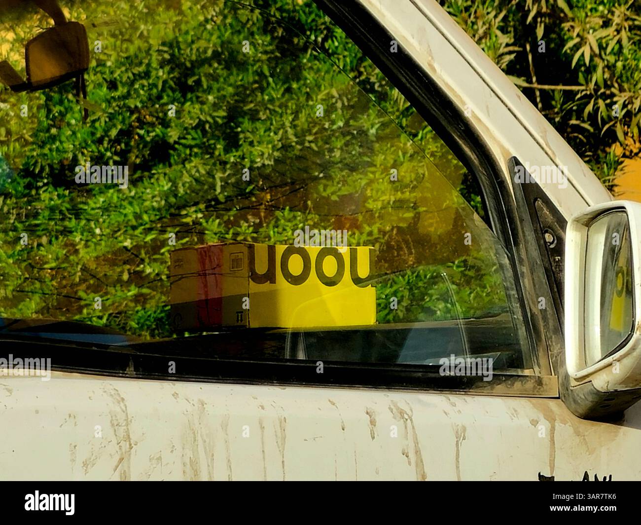 Cairo, Egypt, March 26 2025: Noon online shopping delivery yellow box ...