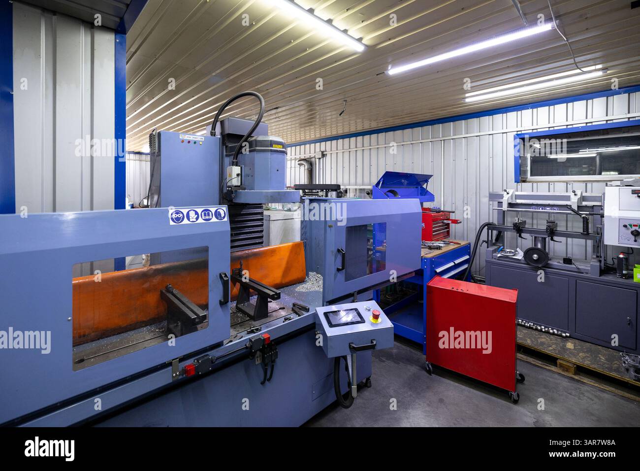 An industrial CNC milling machine is situated within an auto repair ...
