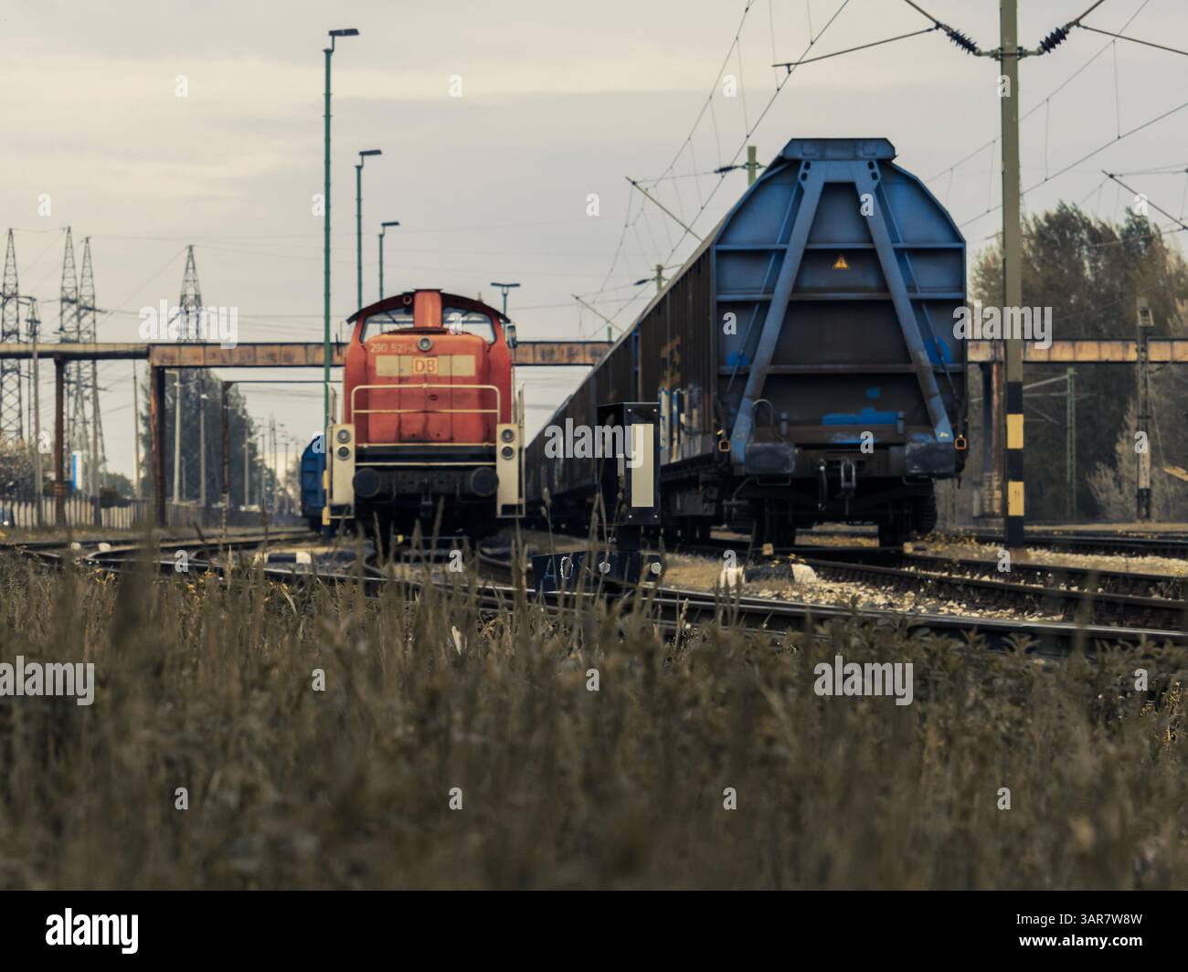 Freight train with red locomotive and blue cargo wagon Stock Photo - Alamy
