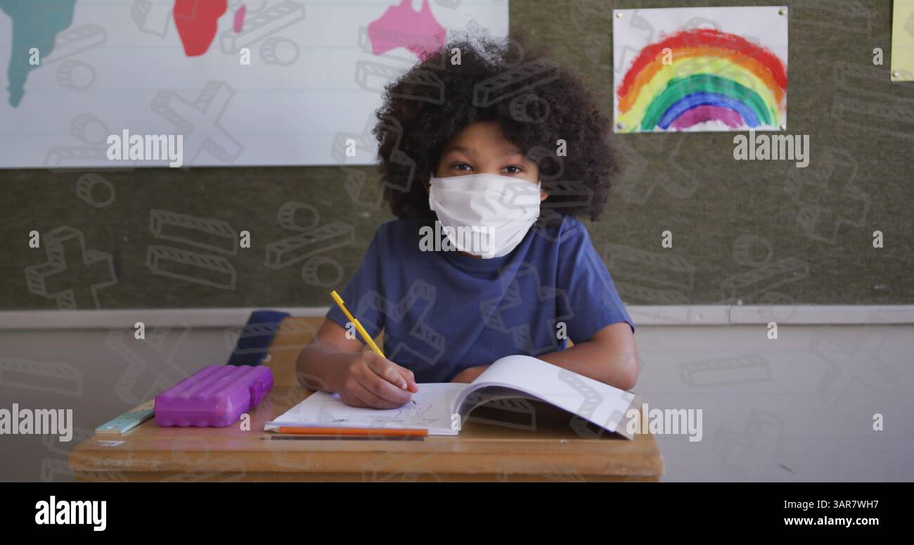 Image of school icons over african american schoolboy wearing face mask ...