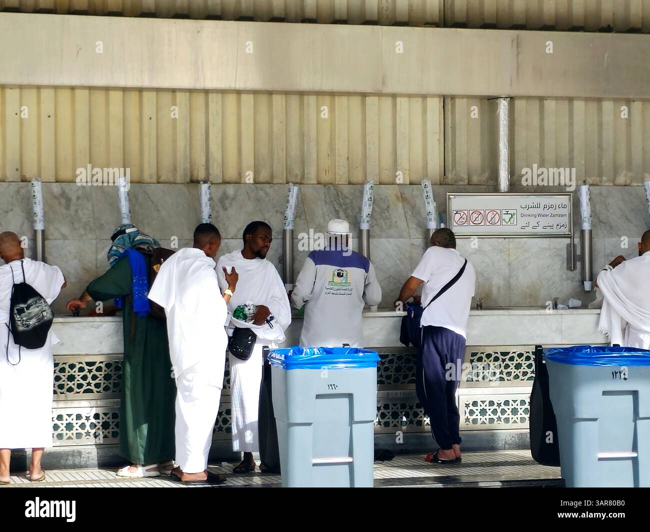Mecca, Saudi Arabia, June 11 2024: pilgrims drinking from Zamzam well ...