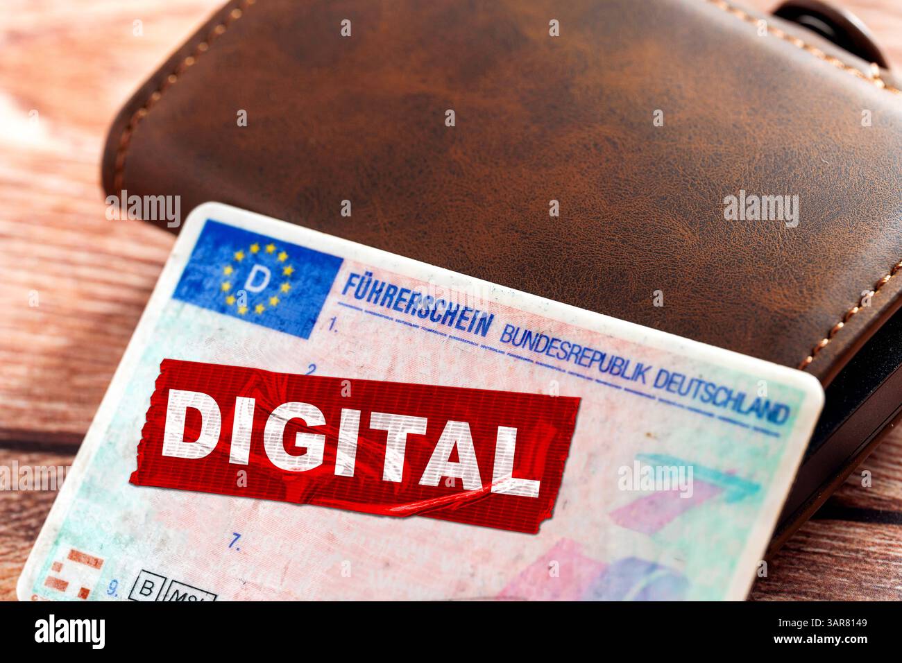 Bavaria, Germany - April 17, 2025: PHOTOMONTAGE, A hand holds a German ...