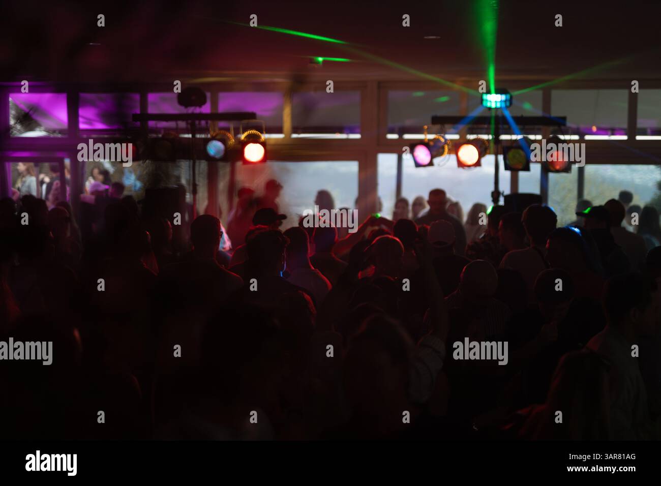 Stuttgart,Germany-5 April 2025. People with raised hands, in disco ...