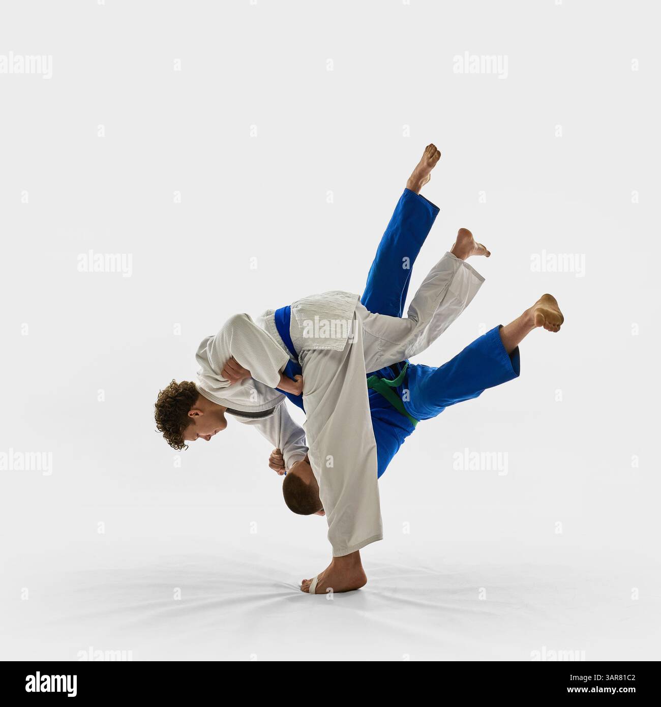Two young athletes in mid-air judo throw, one executing perfect hip ...