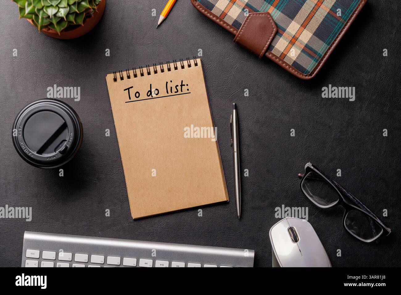 Organized work desk setup with PC, office supplies, coffee and a ...