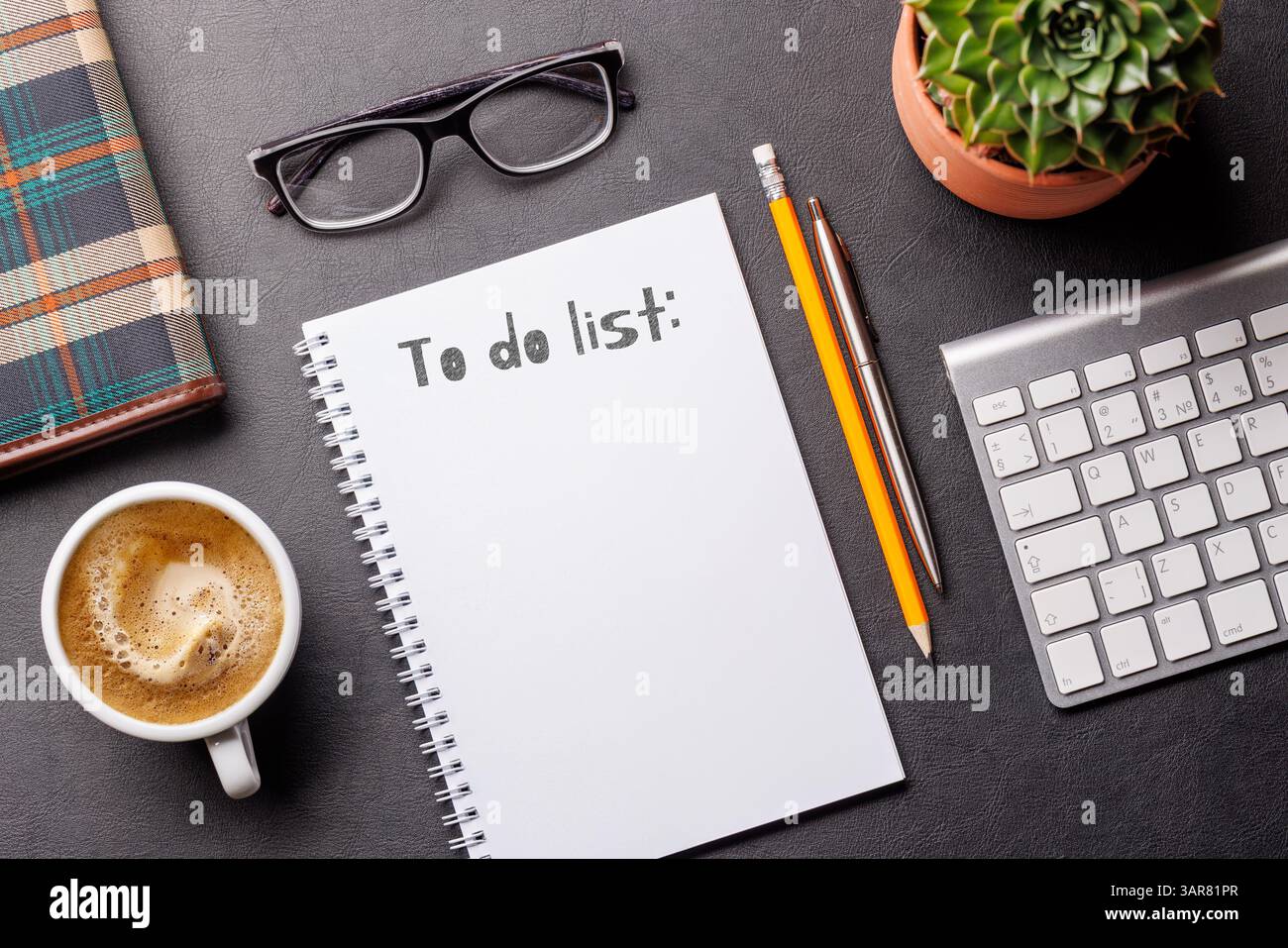Organized work desk setup with PC, office supplies, coffee and a ...