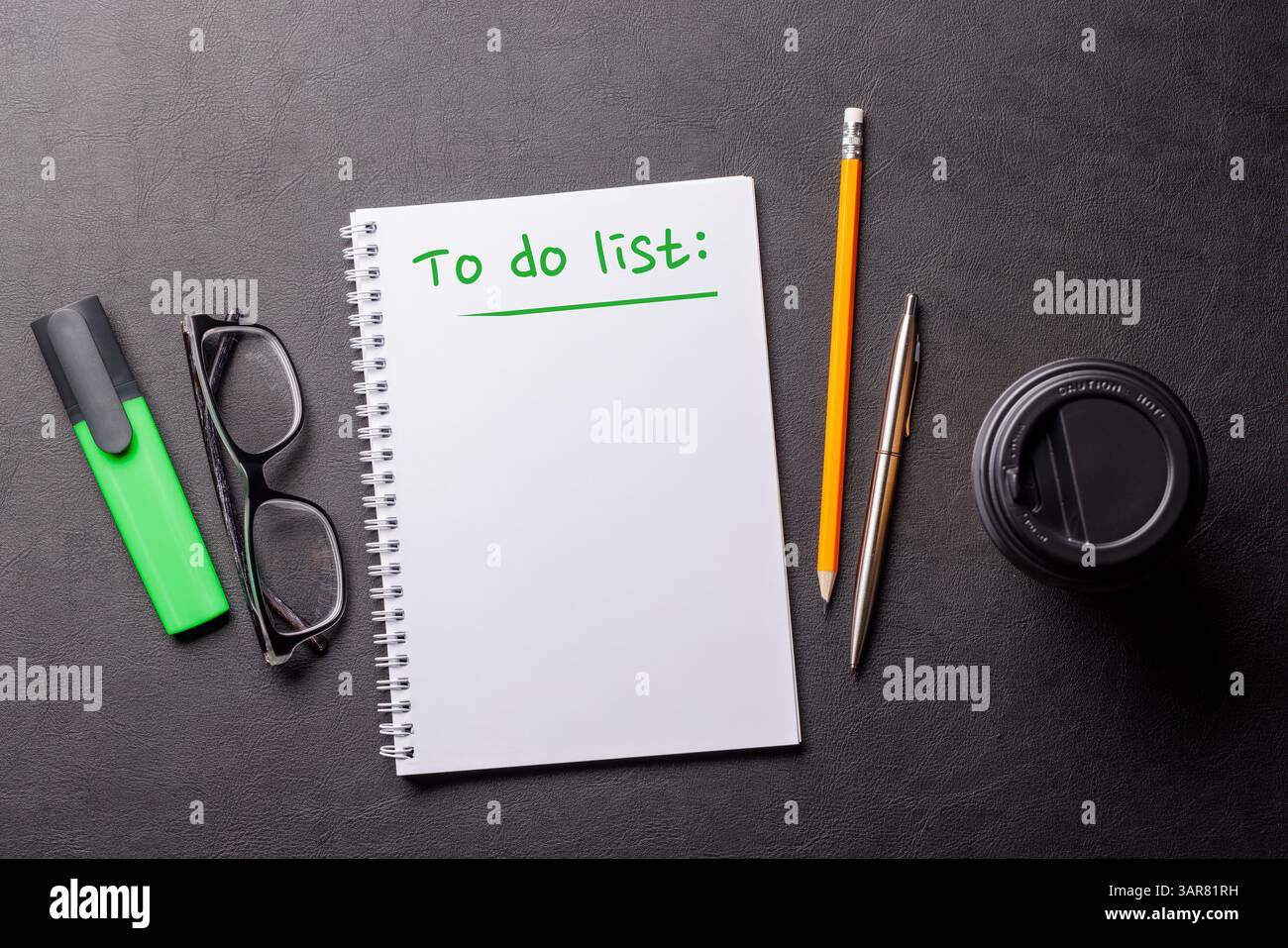 Organized work desk setup with office supplies, coffee and a notepad ...