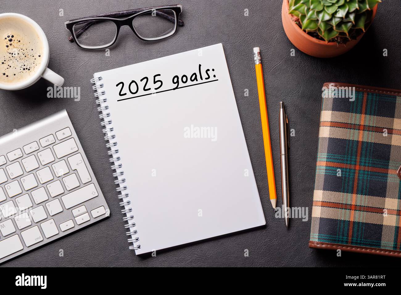 Elegant leather desk setup with laptop, coffee, stationery, and a ...