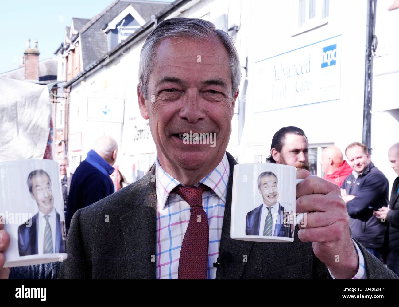 Reform UK leader Nigel Farage holding a mug with his picture on it ...