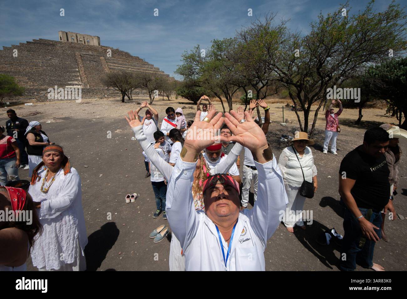 People Welcoming Spring Equinox in Queretaro A man rises his hands ...