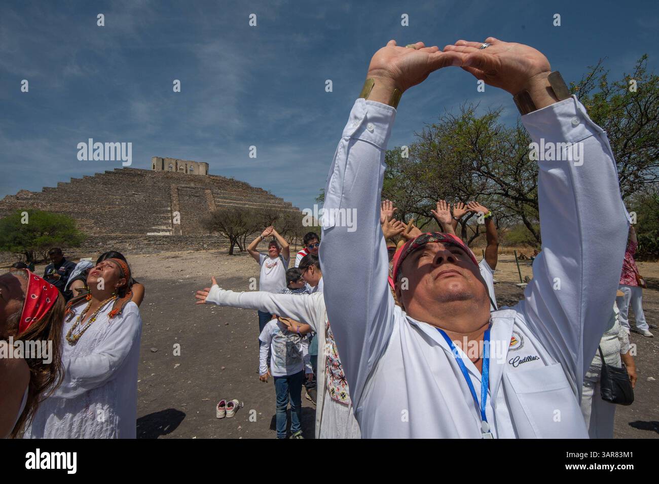 People Welcoming Spring Equinox in Queretaro A man rises his hands ...