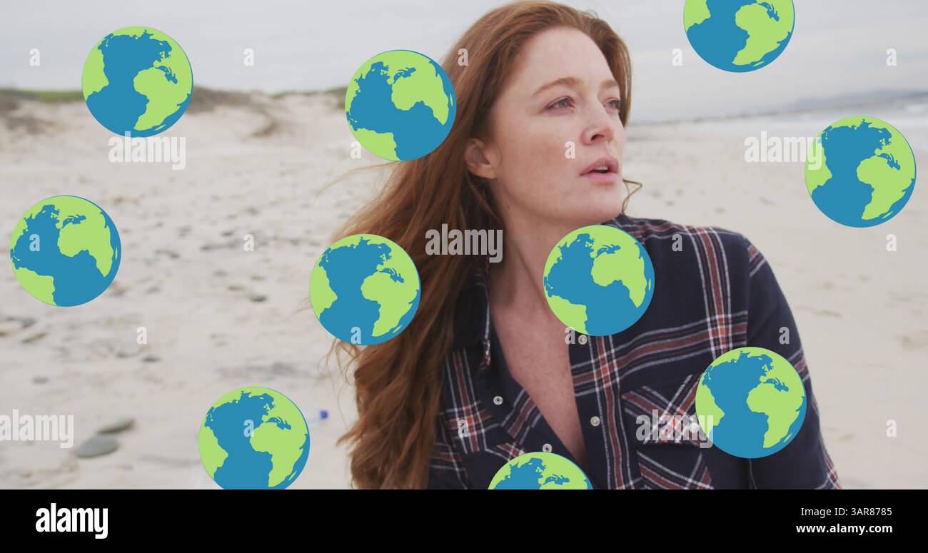 Image of falling globes over caucasian woman picking up rubbish from ...