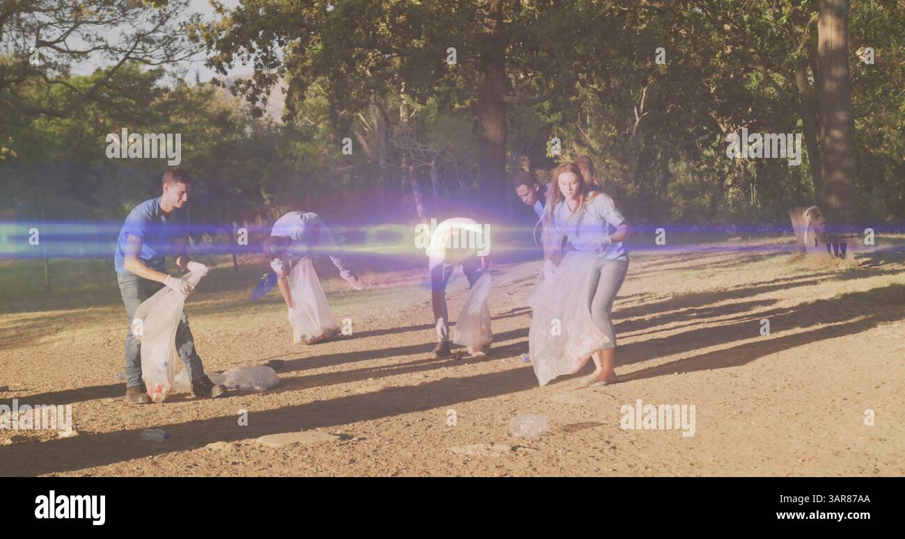 Image of lights over happy diverse group picking up rubbish in ...