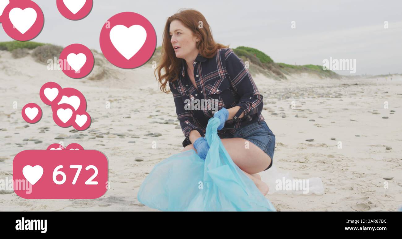 Image of social media heart icons over smiling caucasian woman picking ...