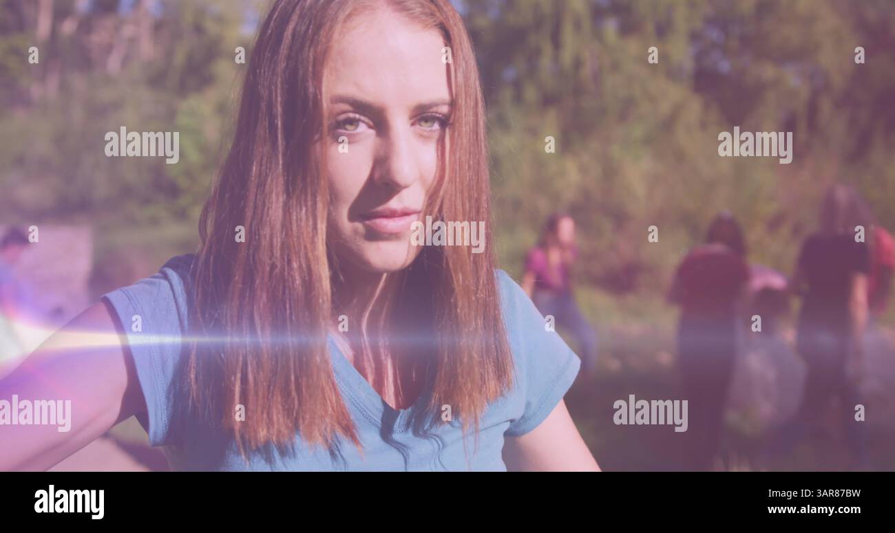 Image of lights over happy caucasian woman picking up rubbish with ...