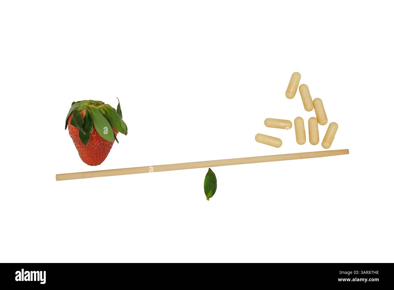 Strawberry, and dietary supplement capsules on the horizontal stick ...