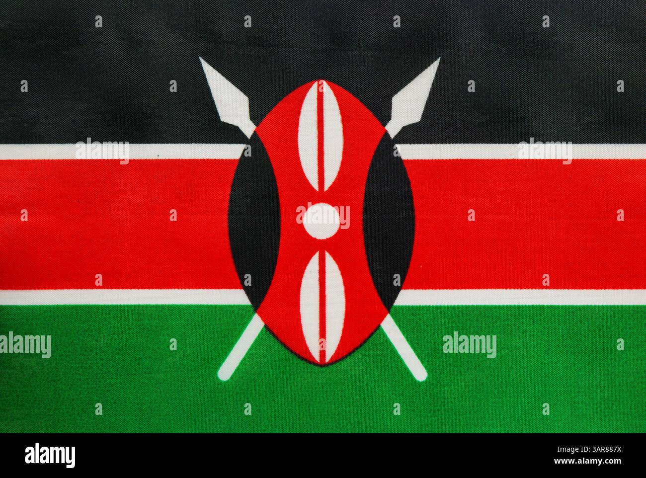 Vibrant Kenyan flag features green, red, black, and white colors with a central shield and ...