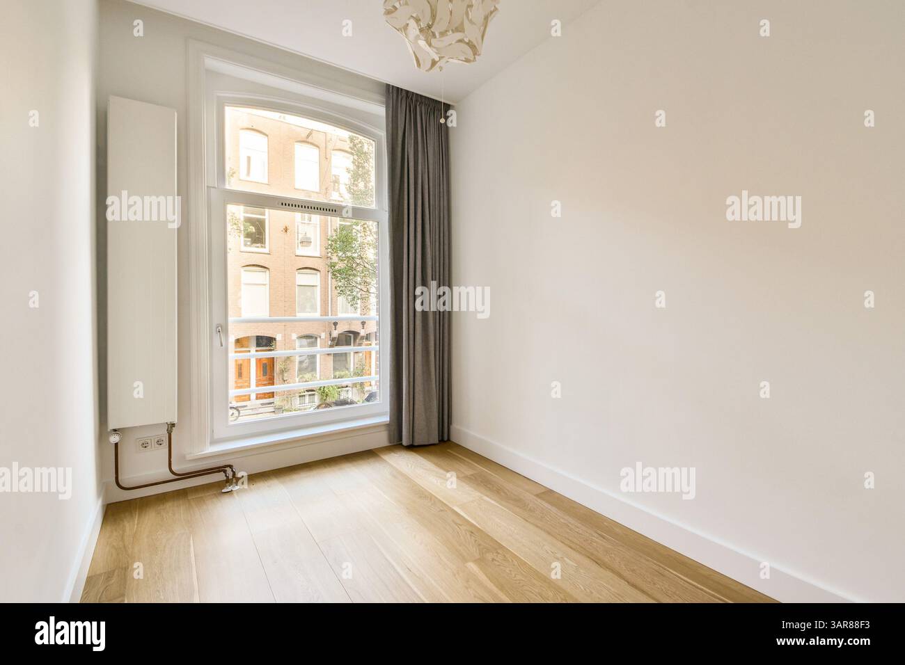 A sleek and airy interior space featuring large windows and soft ...