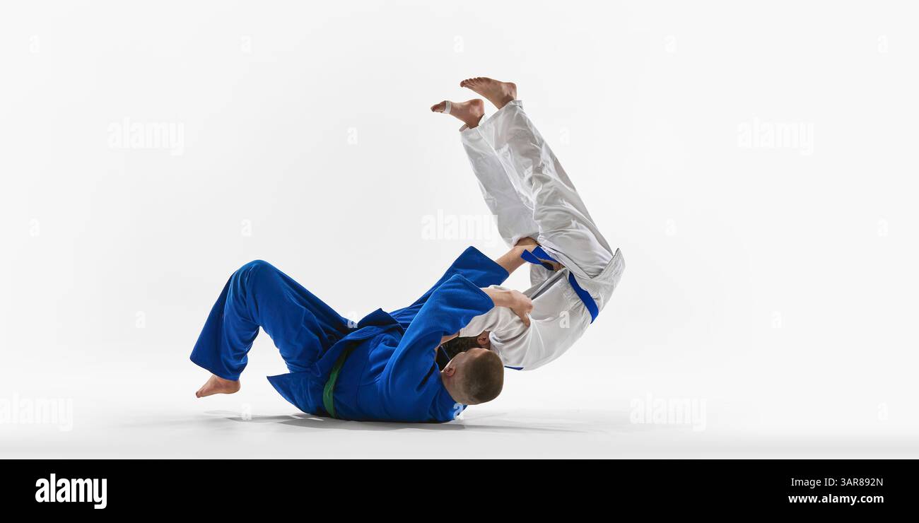 Judoka in blue brings white gi opponent crashing down using classic ...