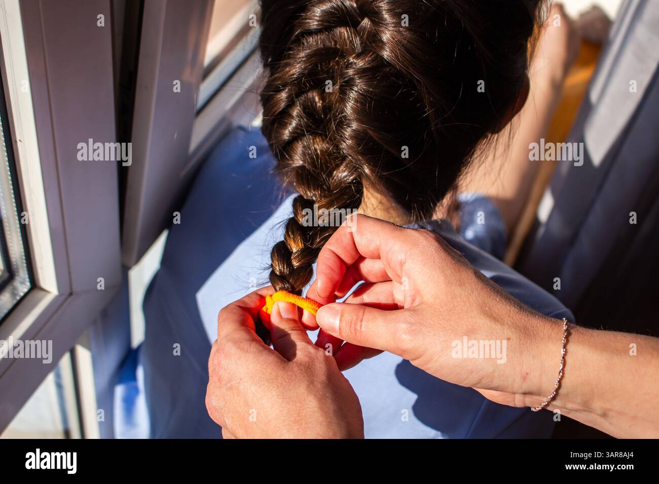 Relaxed morning routine as mom styles daughter's hair. Everyday ...