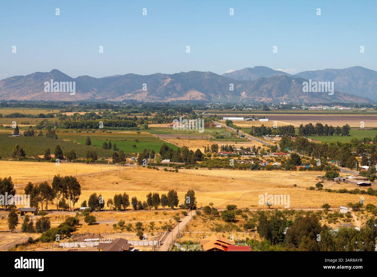 The Landscape with farms and houses and mountains in the horizon ...