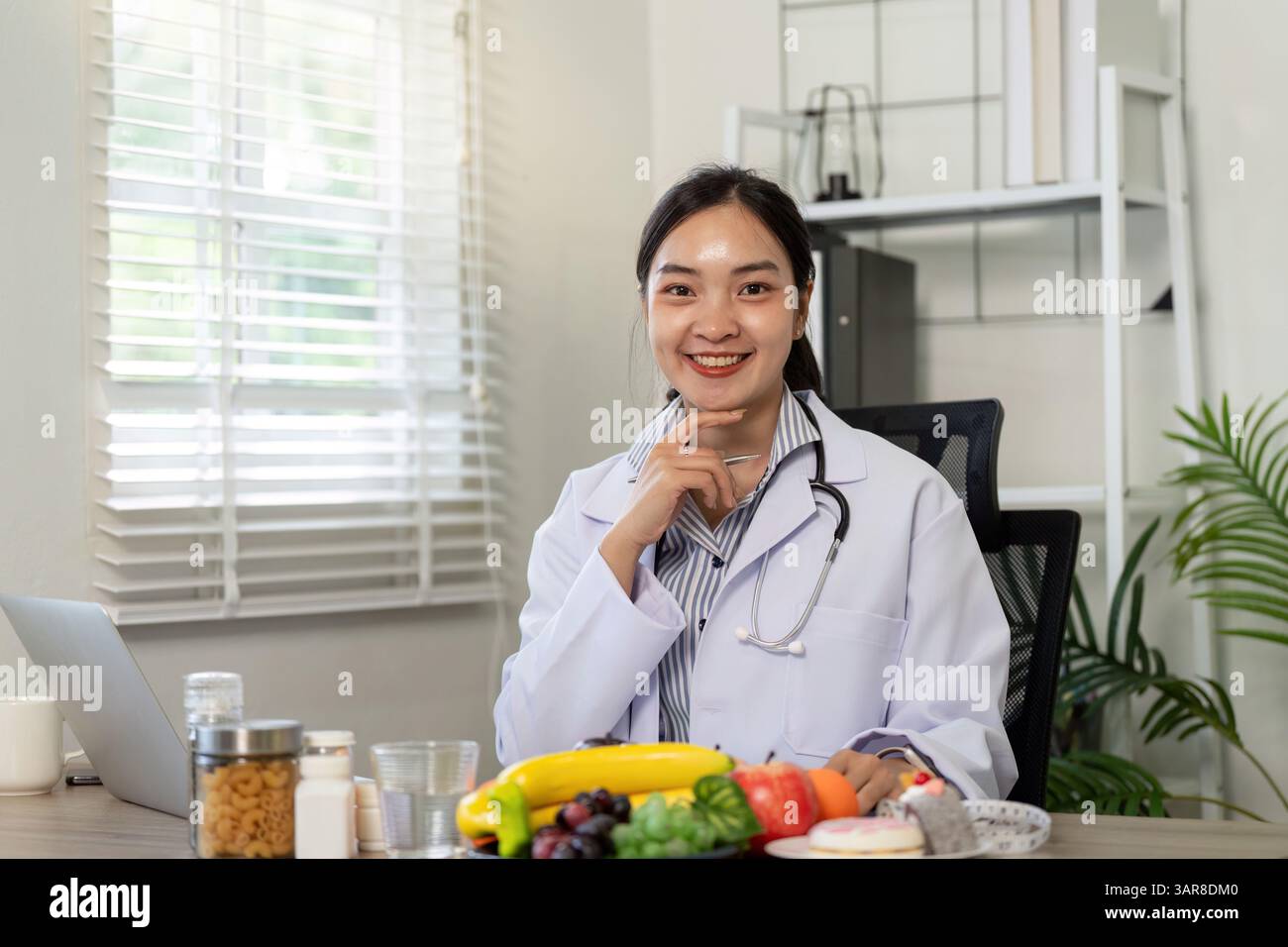 Consultation and Healthy Eating. A nutritionist smiles while promoting ...