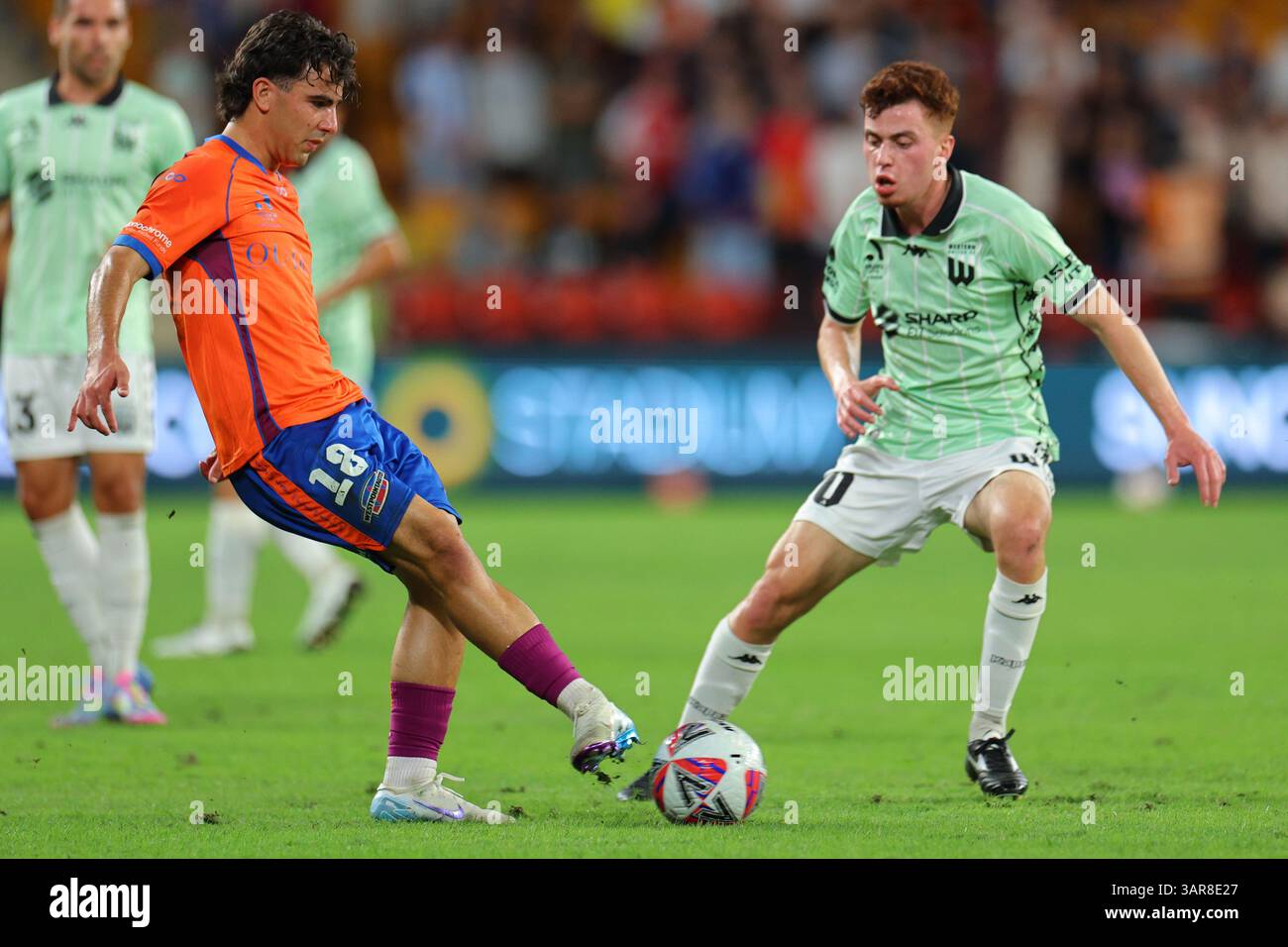 Brisbane, Australia, April 17 2025: Jacob Brazete (18 Brisbane) passes ...