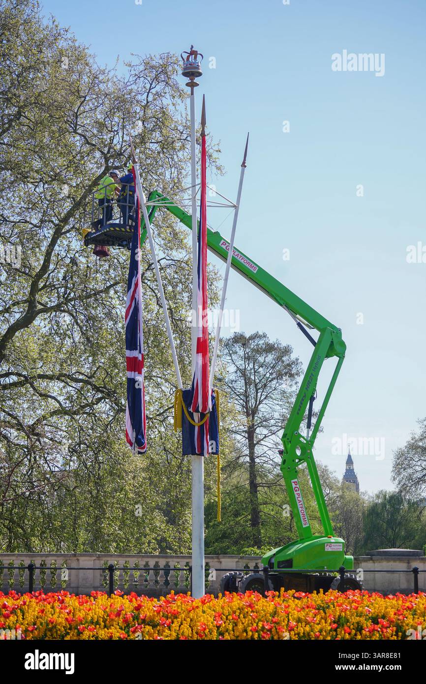 London UK 17 April 2025. Flag engineers perched on a cherry picker ...
